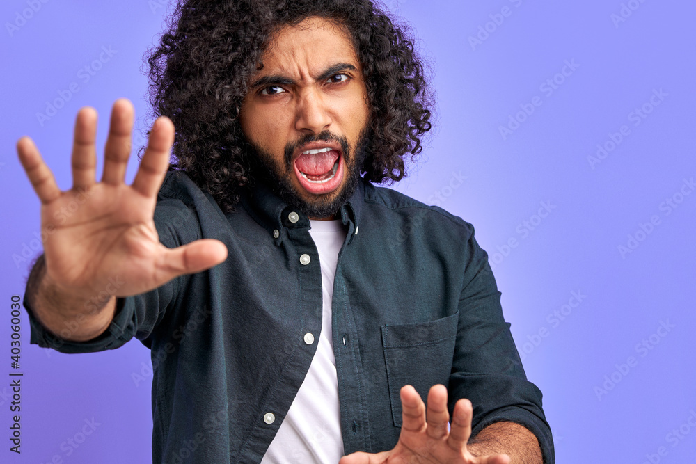 man raising hand up in calm down, wait sec or stop gesture, panick ...