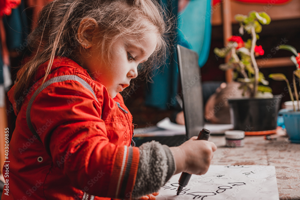 Preschool girl learns to draw a circle, black circles on a white sheet ...