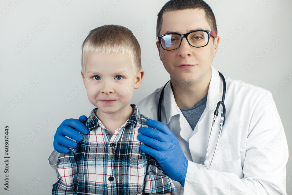 The child hugs the doctor. Examination of the boy by a pediatrician ...