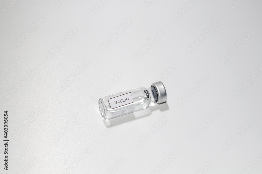Covid-19. A vaccine vial ready to inject to vaccinate. The vial is ...