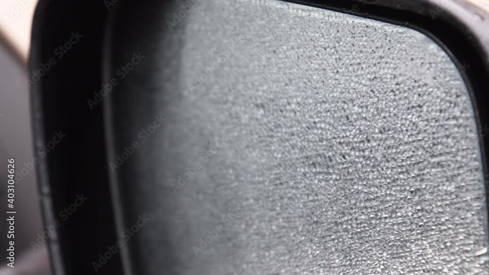 Defocus side mirror of car with blurred raindrops dots on glass window ...