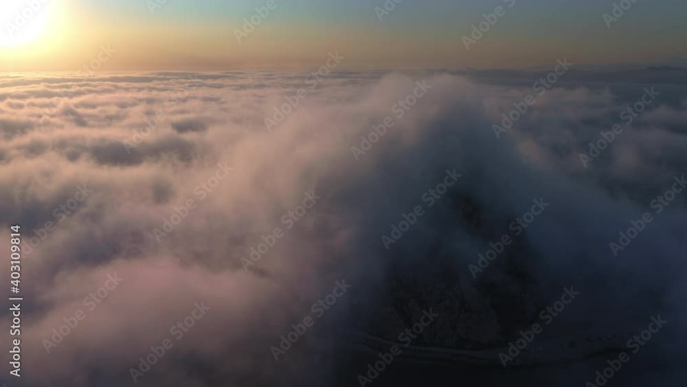 Cinematic golden sunset or sunrise over the cloudscape. Scenic aerial view at dusk or dawn time ...