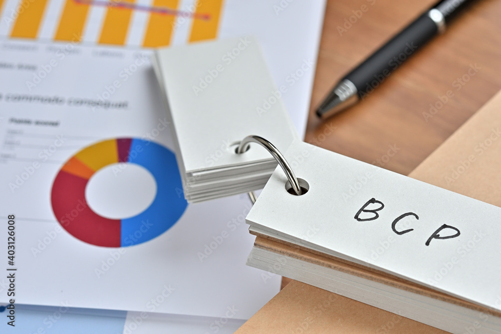 There is a piece of paper with a graph printed on it, a notebook, and ...