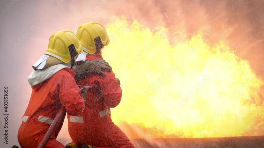 Firefighter teamwork in fire protection suit on safety rescue duty ...