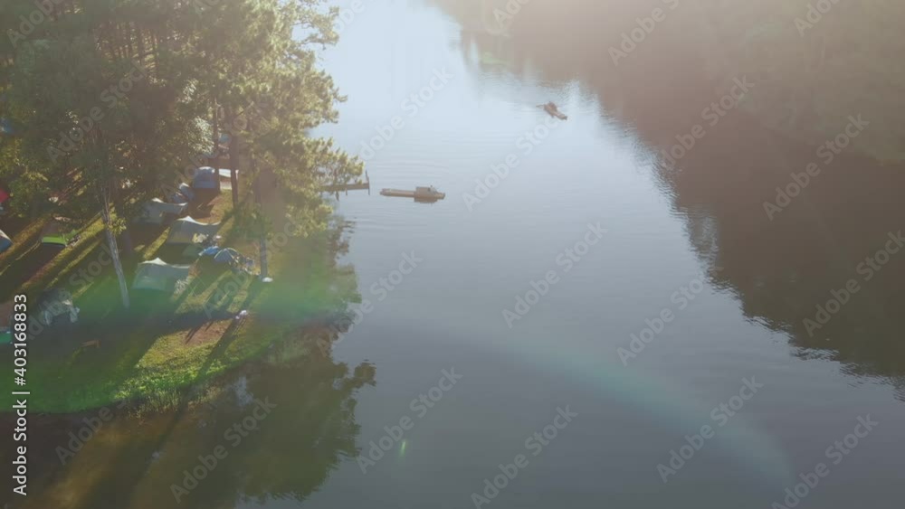 Aerial top view and tilt up, Morning sunlight at Pang Ung lake with ...