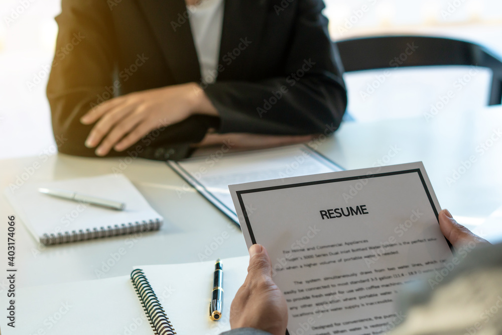 job interview in office, focus on resume writing tips, employer ...