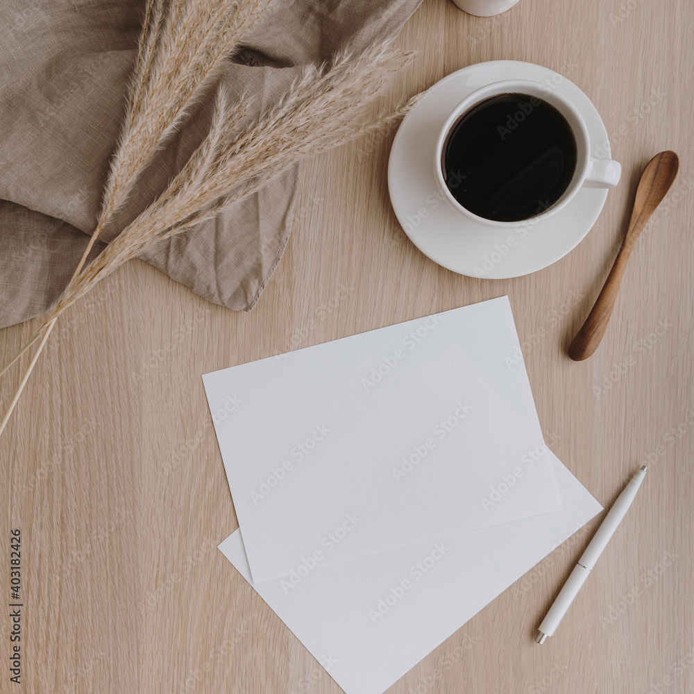 Blank paper sheet on beige wooden table. Artist home office desk ...