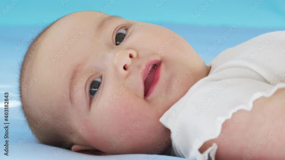 Close-up portrait a infant girl. The face of a Caucasian little girl ...