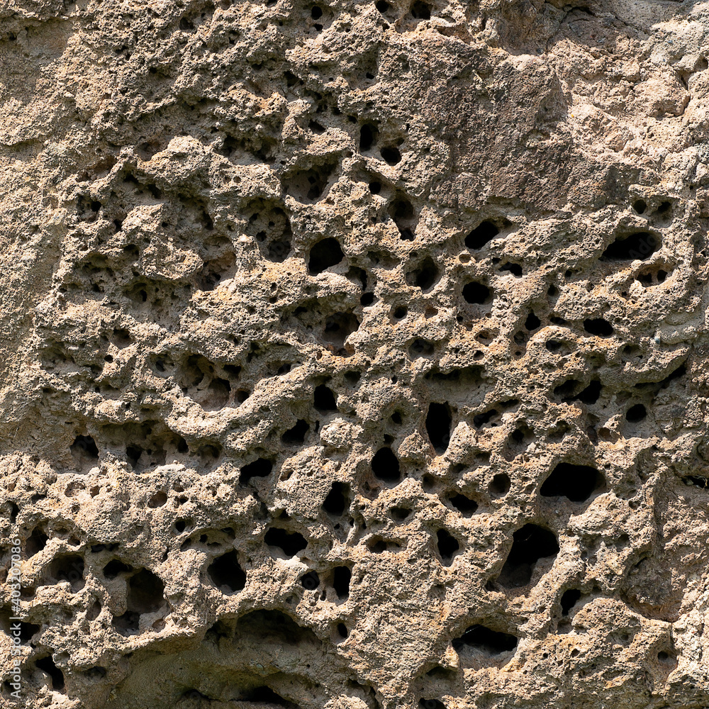 Background with a texture of a fragment of an ancient stone wall of an ...