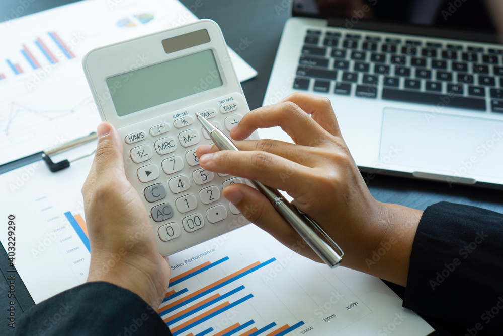 Female Asian finance workers are calculating the company's performance ...
