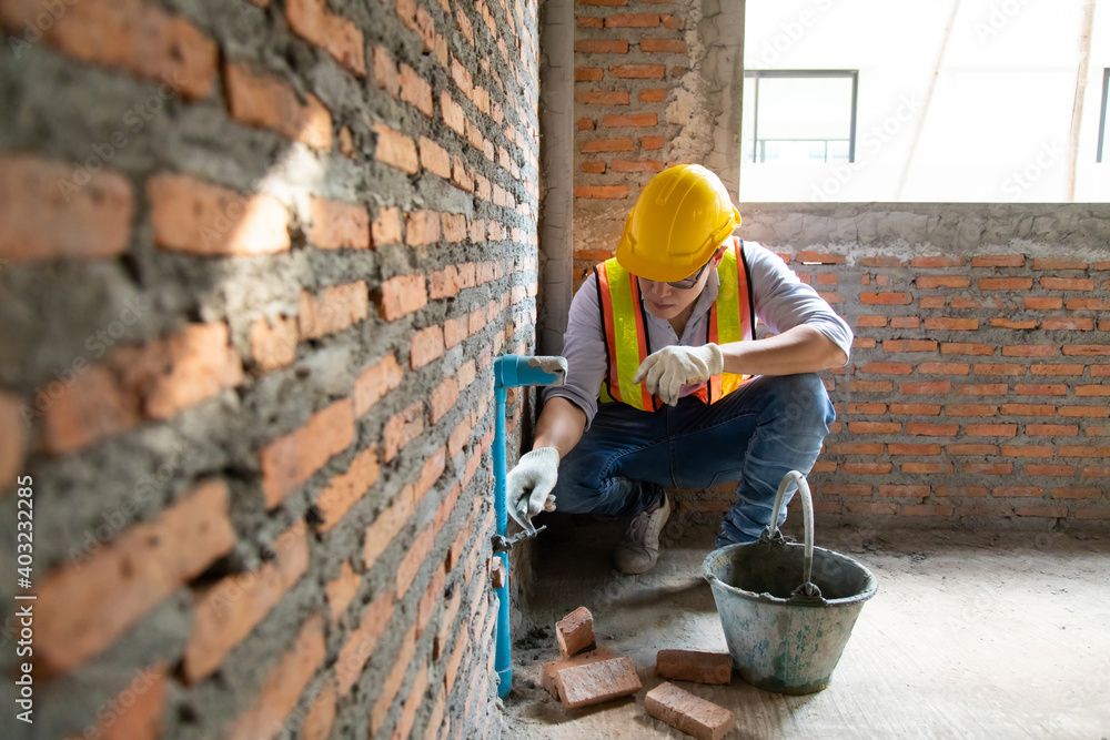 Man bricklayer installing bricks on construction site Stock Photo ...