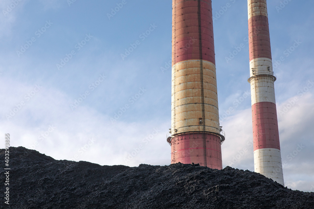 Coal heap, natural black coal with industrial chimneys. Industrial ...