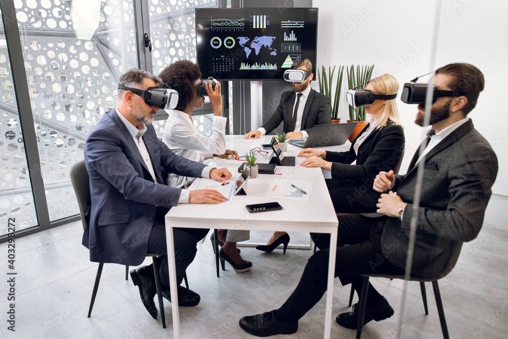 Multiethnic creative business team using virtual reality headsets at ...