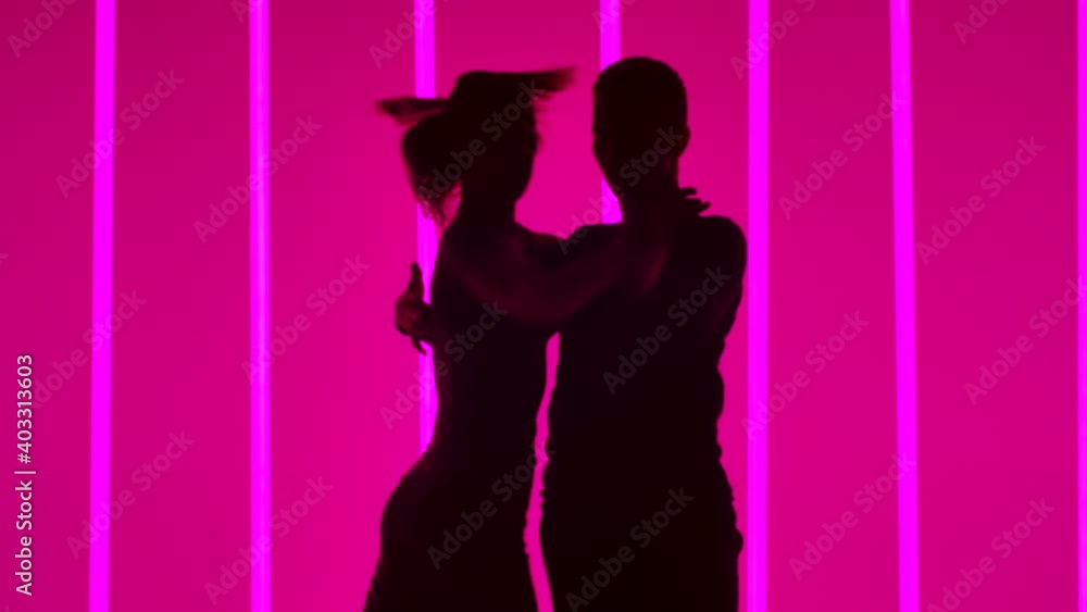 Beautiful dance partners practice dance moves in the studio, spinning ...