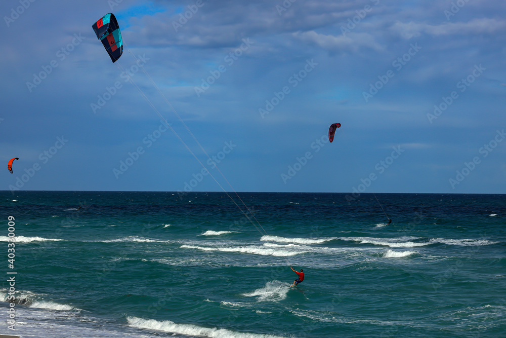 Poster Kite surfing on a windy day offshore in Juno Beach Florida ...