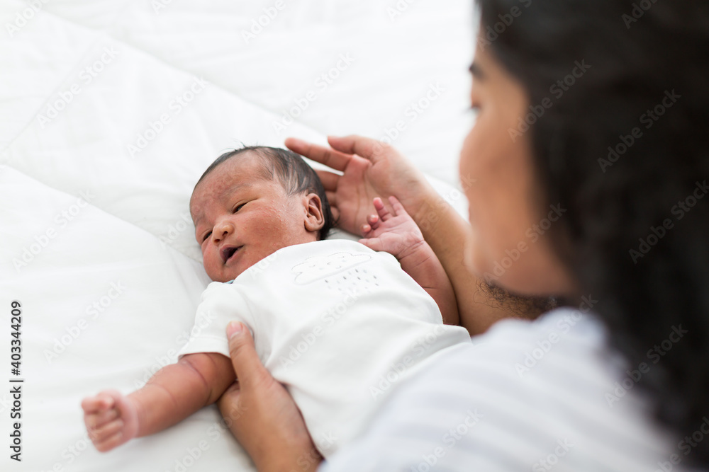 African American newborn baby or Infant lying in blanket on white bed ...