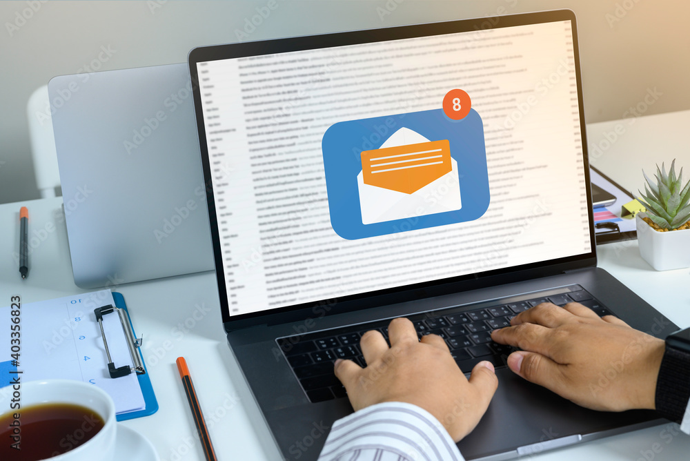 Person using a laptop computer with email communication connection ...