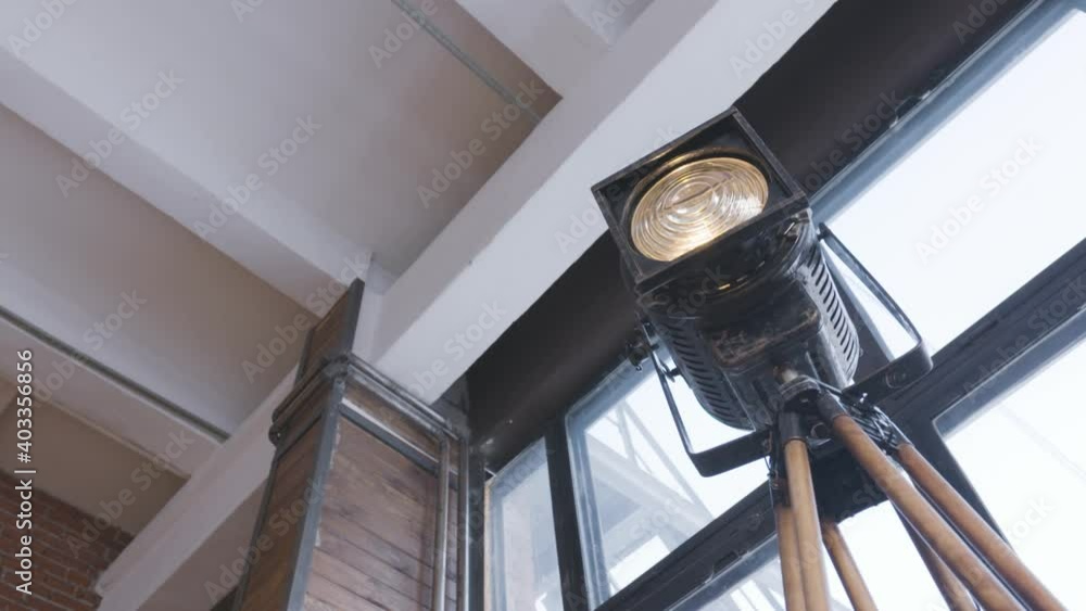 Flashing studio light. Action. Old studio lantern on wooden legs for ...