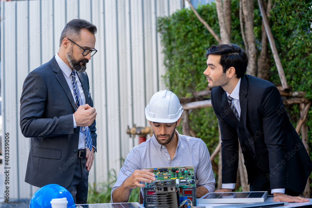Business people Talk to electrical engineer technician of renewable ...
