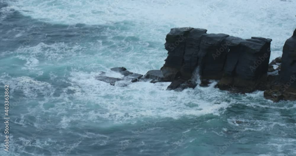 Heavy wave breaking in slow motion. Storm waves on sea or ocean rocks ...
