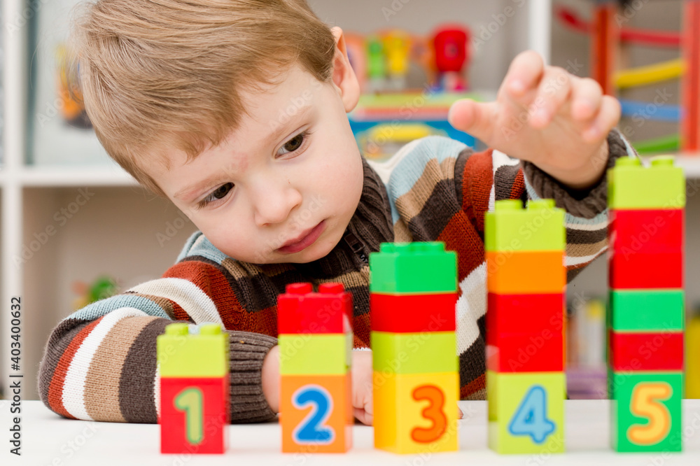 Learning to count. 2 year old boy stacking Duplo blocks. children ...