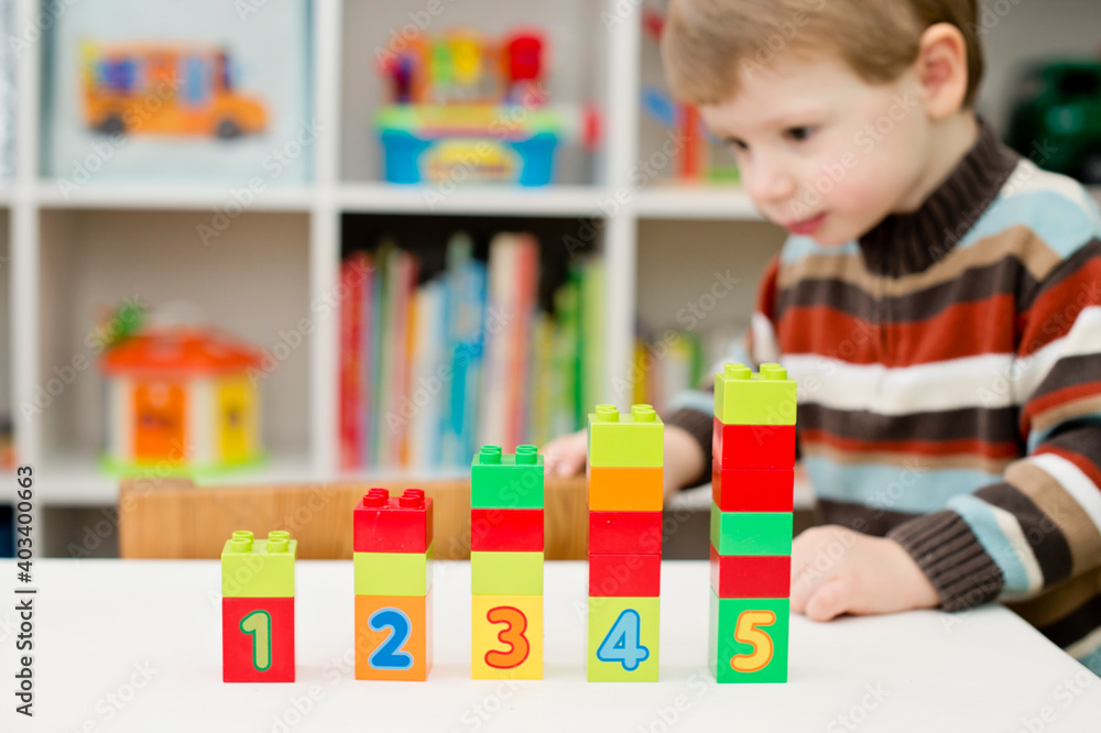 Learning to count. 2 year old boy stacking Duplo blocks. children ...