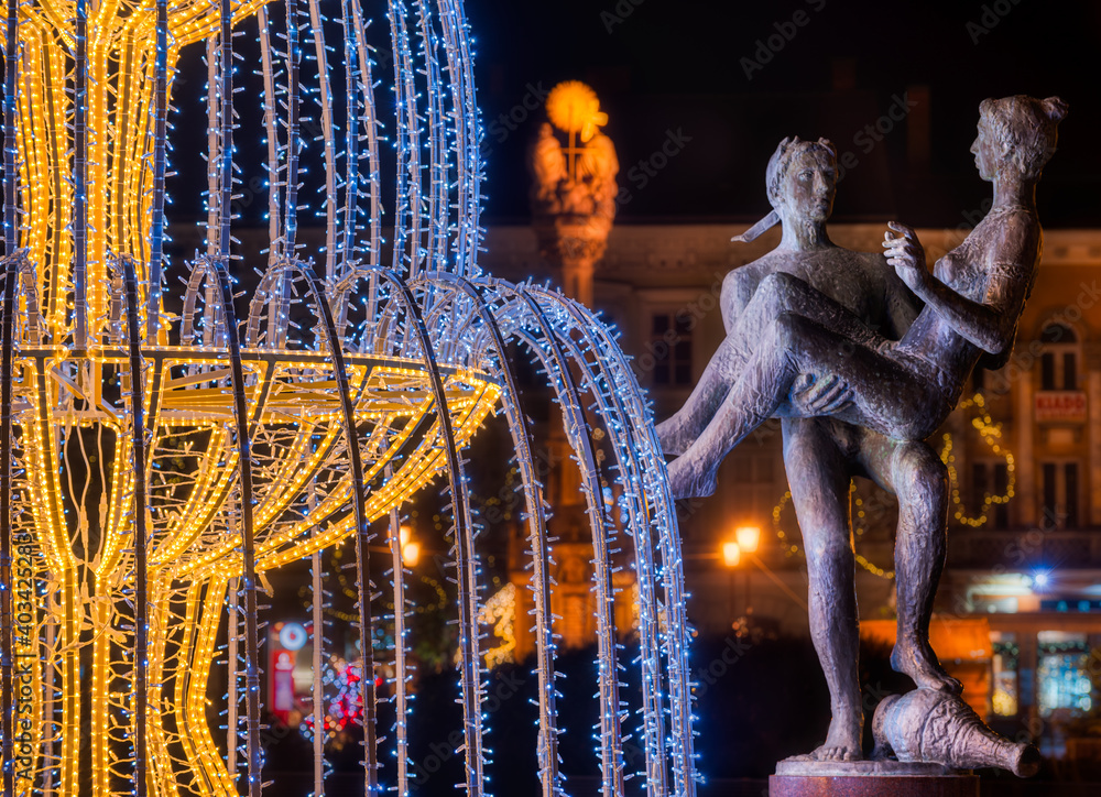 Ornate illuminated fountain shape with a pair's sculpture with the ...