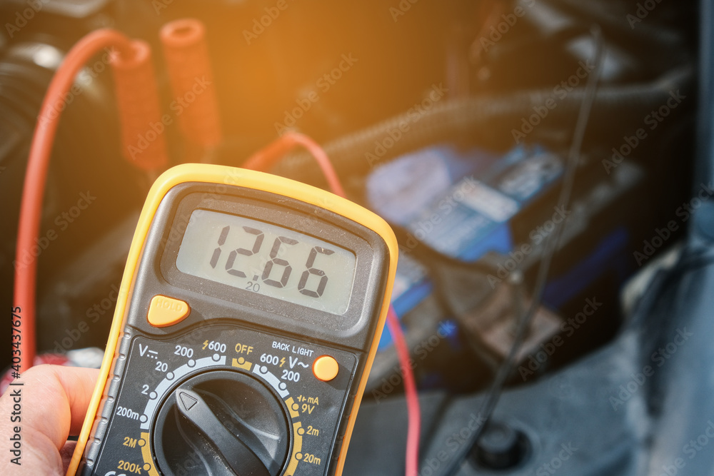 Mechanic hand use multimeter voltmeter to check the voltage level Stock ...