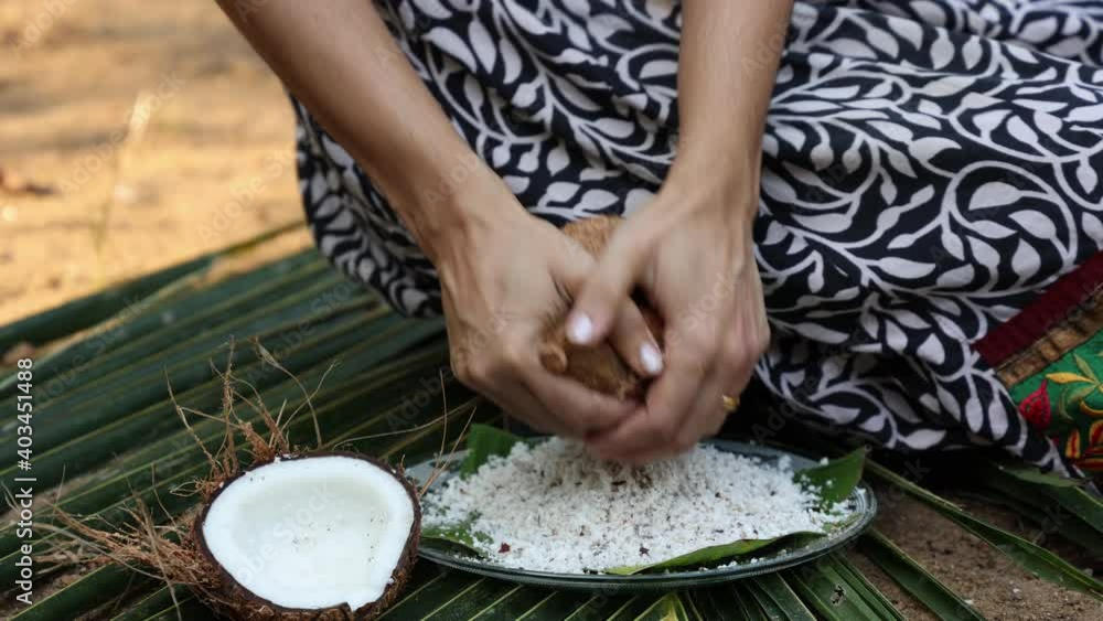 Woman hand grating fresh raw coconut cut open in half 4K slow motion ...