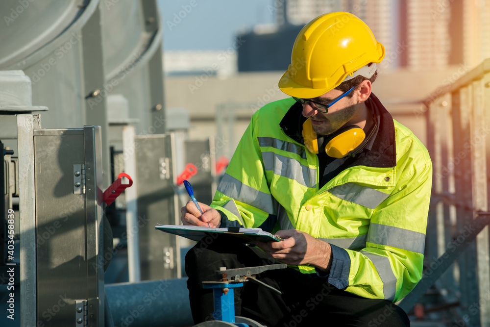 worker open valve of cooling tower on blue sky background. worker ...