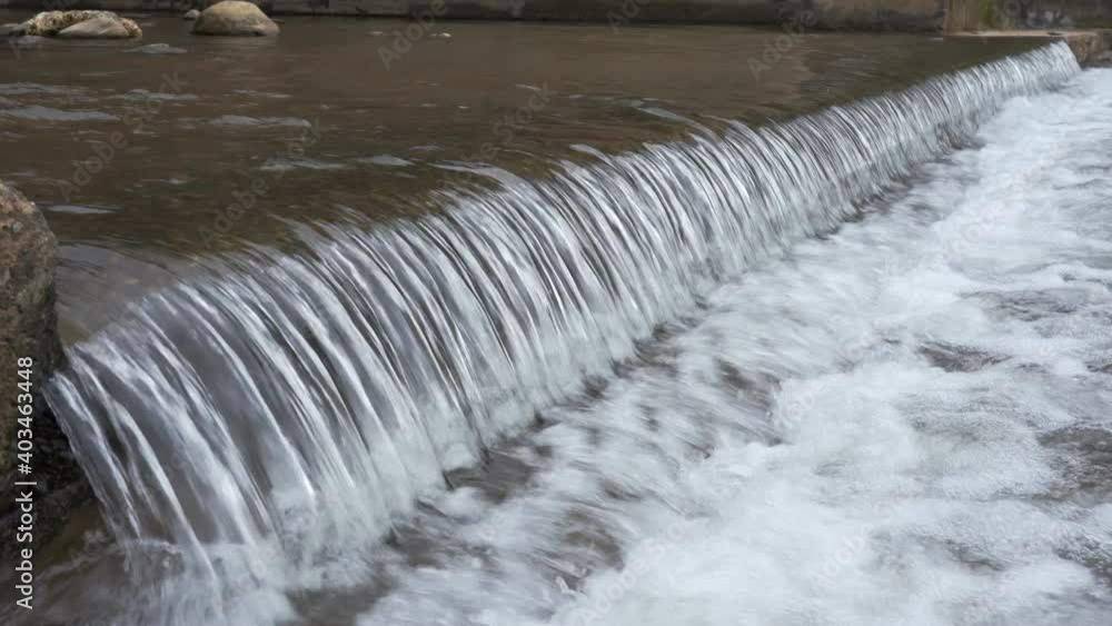 The water flow pass the weir from upper level to lower level, Water ...