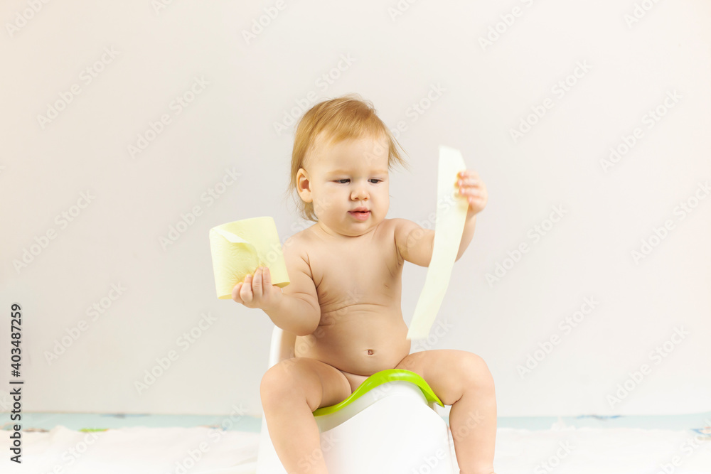 baby sits on a baby potty. Children's hygiene. Potty training. Stock ...