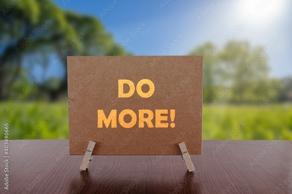 Do more text on card on the table with sunny green park background ...