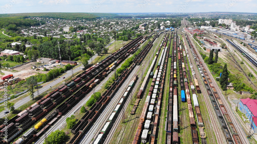 Aerial. Freight trains stand at the depot and await loading. View above ...