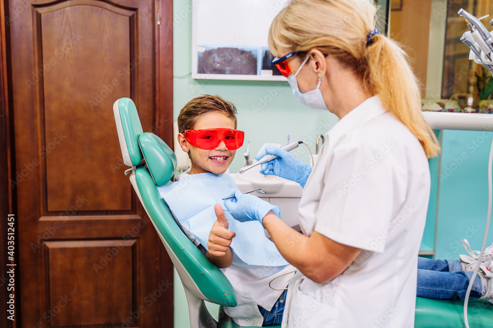 A cute baby is being examined by a professional pediatric dentist. Very ...