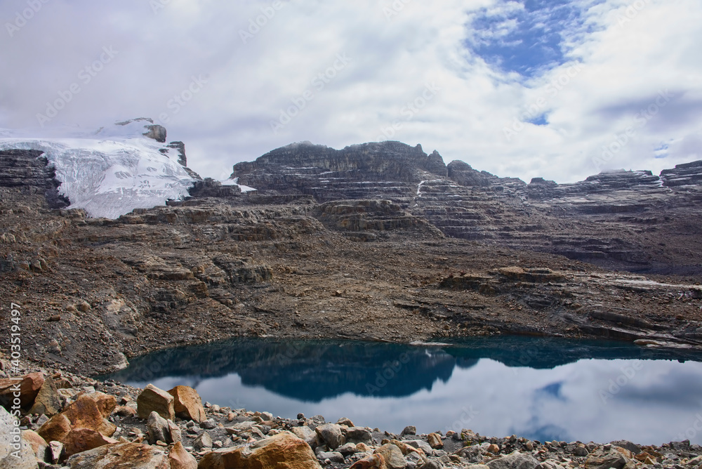 Pan de Azucar and Pulpito Del Diablo reflected in high altitude tarn ...