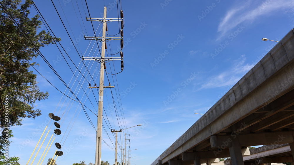 Power transmission lines on concrete poles. High and low voltage cables ...