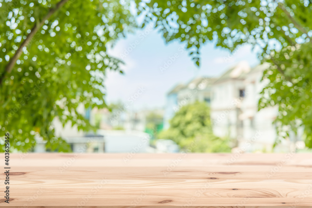 Green town home eco community blur background with wooden table ...