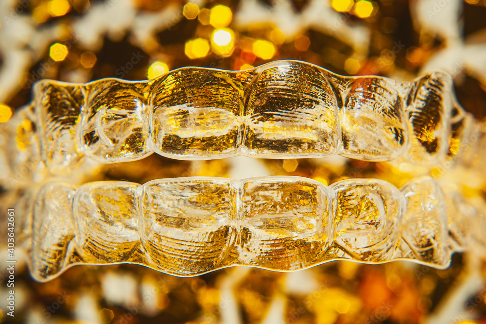 Invisible dental teeth brackets tooth aligners on gold background ...