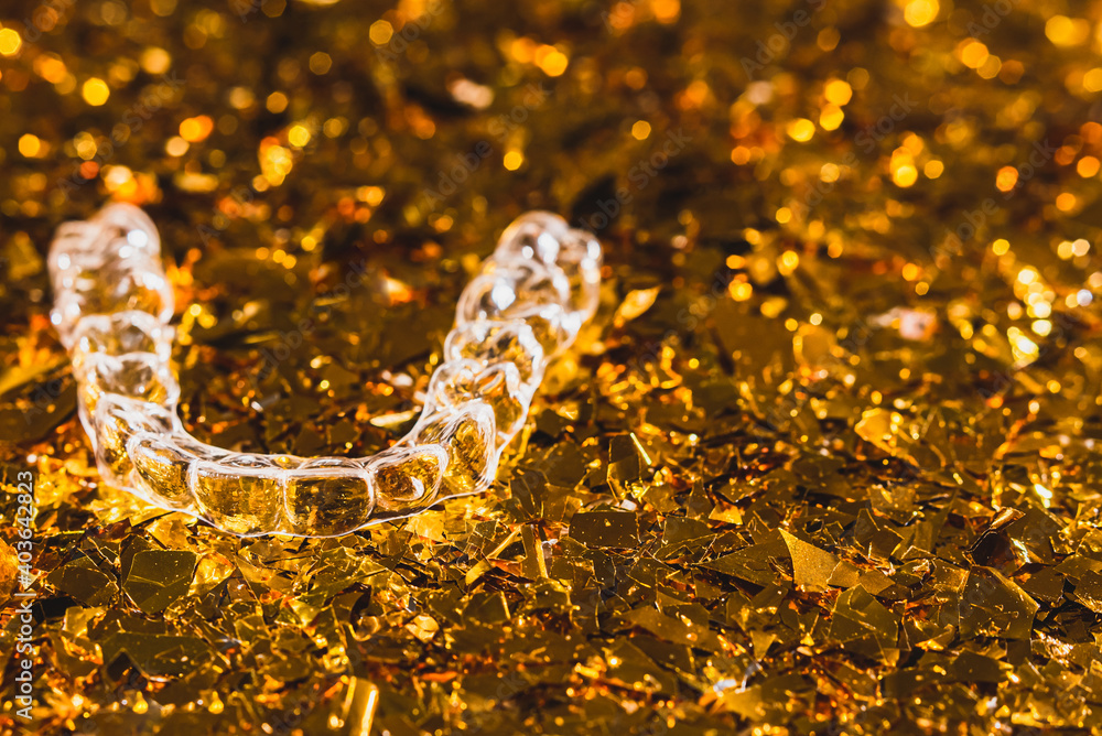 Invisible aligner teeth retainers on a gold background Stock Photo ...