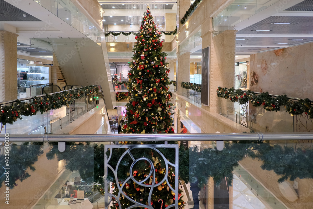 Interior of contemporary shopping mall with Christmas tree and ...