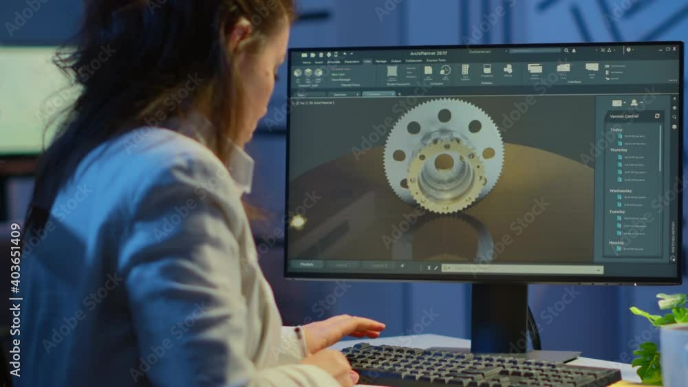 Woman architect working in modern cad program overtime sitting at desk ...