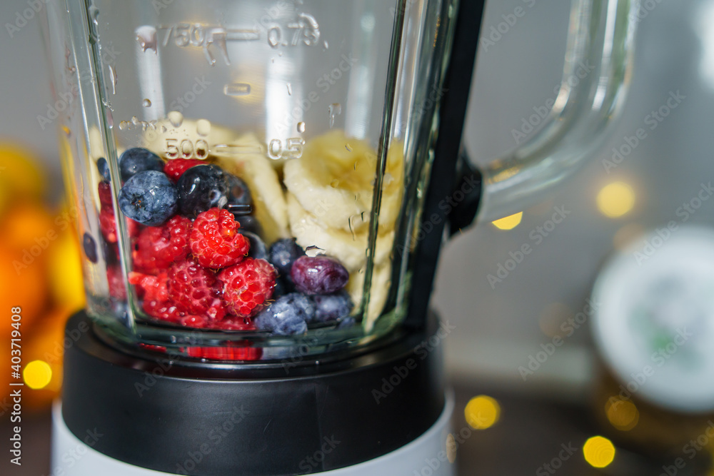 front view on fruits in blender - fresh organic blueberries raspberries ...