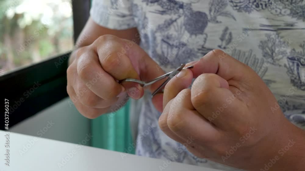 Video Stock Hand used Nipper type tool to trim fingernails on little ...