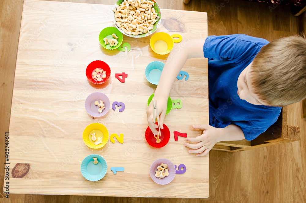 Little child doing simple math exercises. Early education, counting ...
