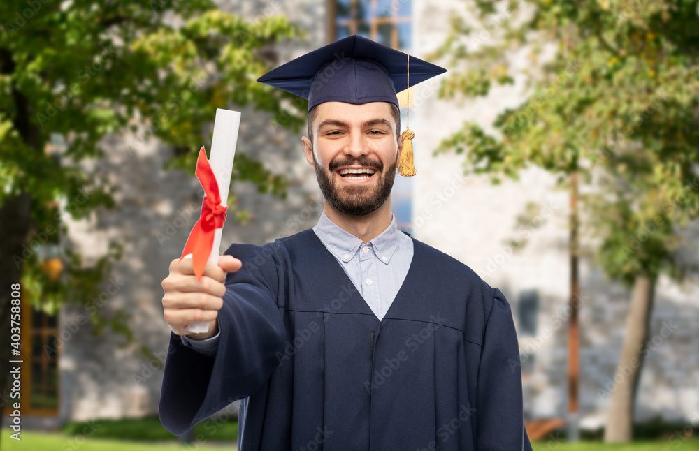 education, graduation and people concept - happy smiling male graduate ...