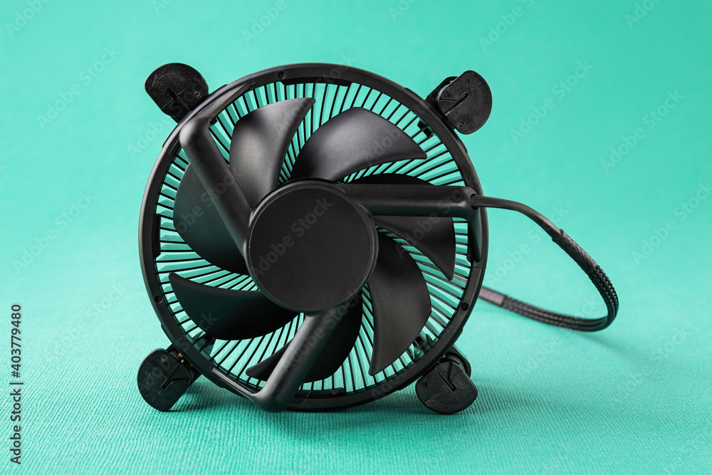 Computer CPU cooling fan radiator on its side over a turquoise blue ...