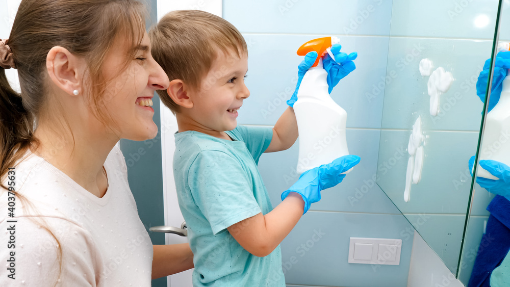 Happy smiling mother with little toddler son applying chemical ...