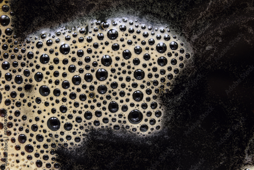 Surface of fizzy foamed brown beverage. Texture surface of drink with ...