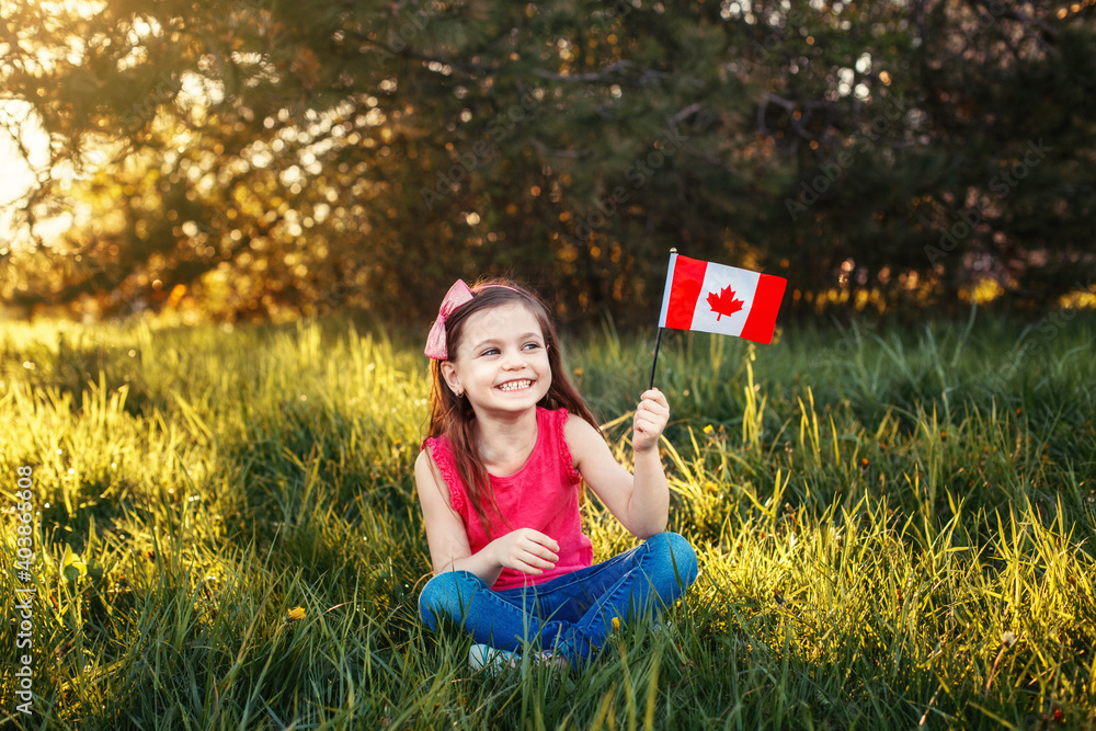 Adorable cute happy Caucasian girl holding Canadian flag. Smiling child ...